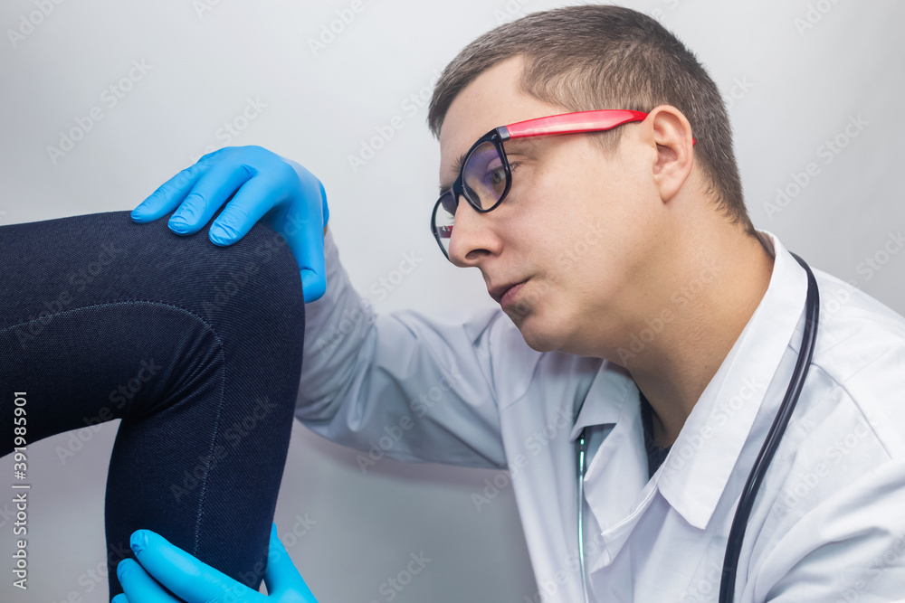 A woman suffers from knee pain. Examination by an orthopedist and ...