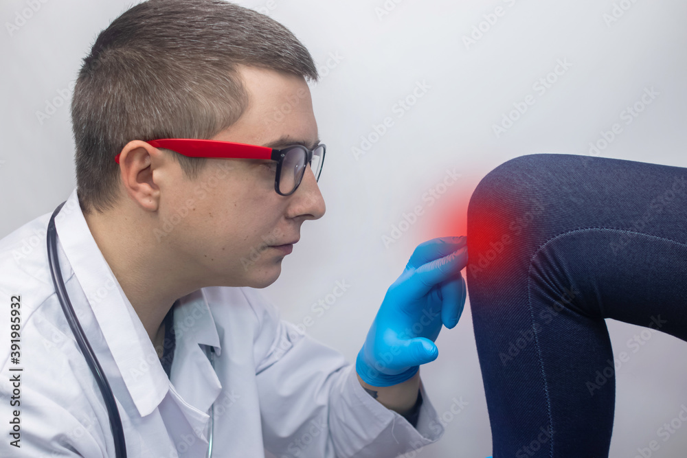 A woman suffers from knee pain. Examination by an orthopedist and ...