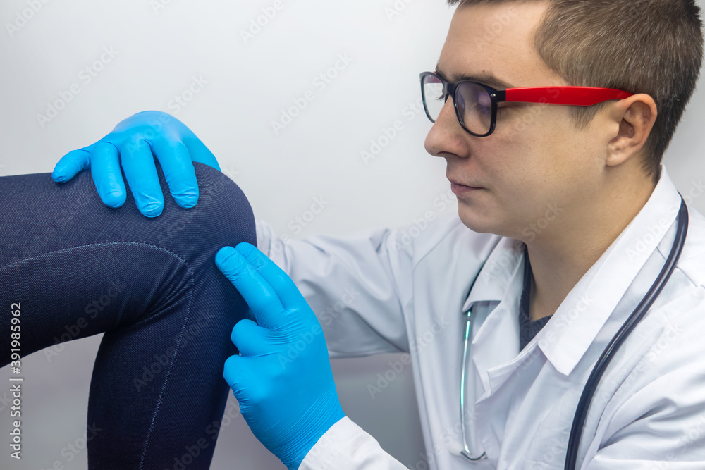 A woman suffers from knee pain. Examination by an orthopedist and ...