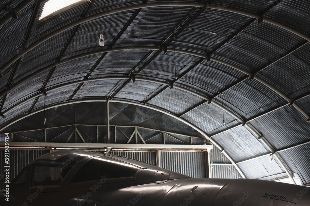 Moody shot of a fighter jet aircraft in a big aviation hanger Stock ...