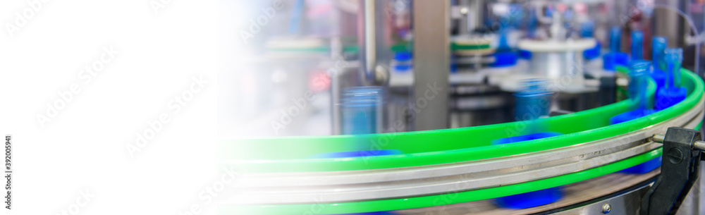 Clear blue glass bottles transfer on Automated conveyor systems ...