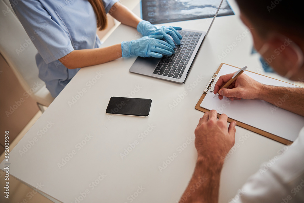 Responsible visitor of doctor office checking in and wearing mask Stock ...