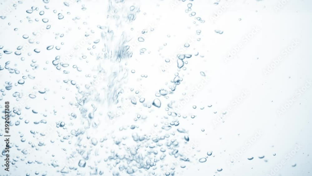 Water stream in slow motion falls on smooth clean surface, creating air ...