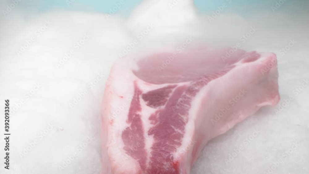 extreme close-up, detailed. pork steak on the bone on dry ice with ...