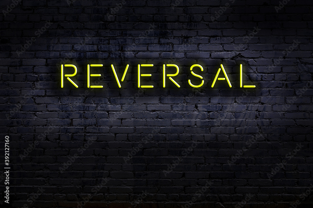 Neon sign. Word reversal against brick wall. Night view Stock ...