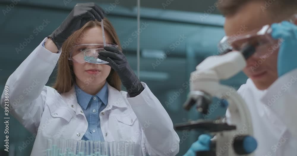 inside laboratory of pharmaceutical company, people are working over ...