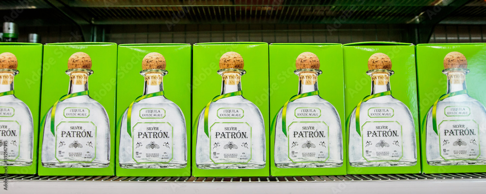Packages of Patron Tequila stand on a shelf in a liquor store. Stock ...