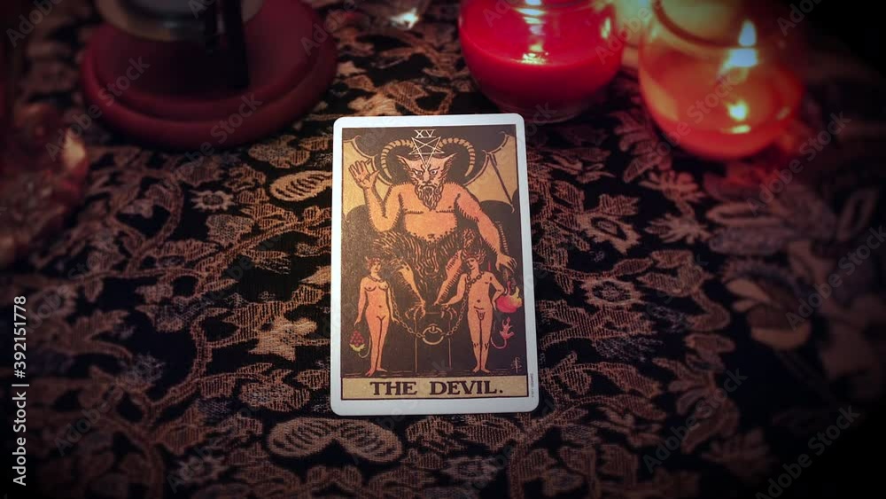 Video Stock A mystical fortune teller selects a Tarot card and places ...