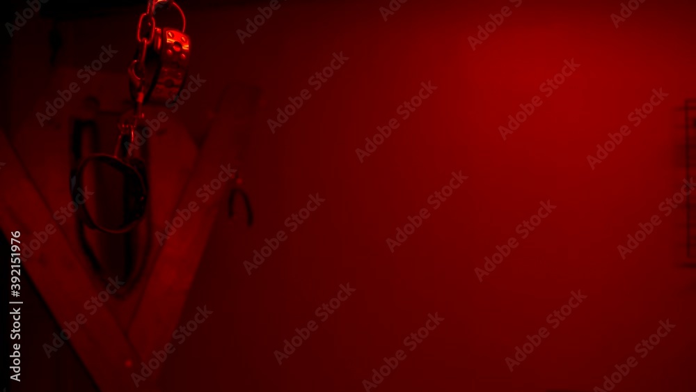 Handcuffs on the ceiling in a red bondage room. Stock Video | Adobe Stock