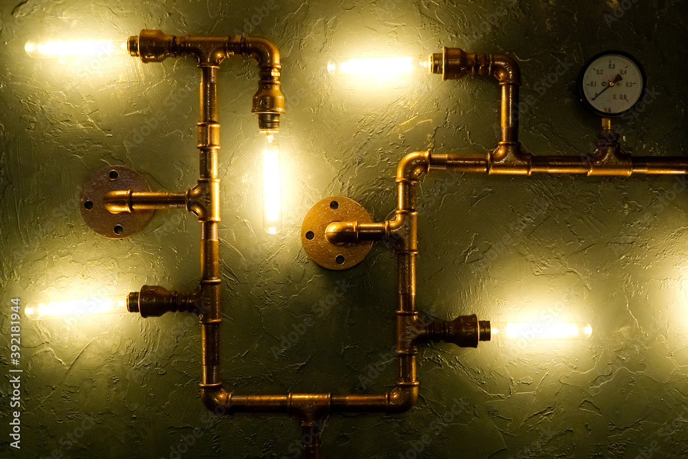 Modern led light made from water pipes. Rustic design, stucco wall with ...