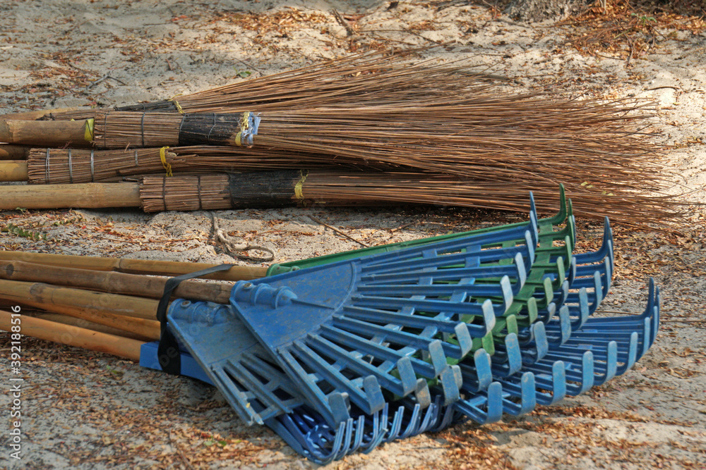 Sweeping rake and Broom grass put on the ground preparing for cleaning ...
