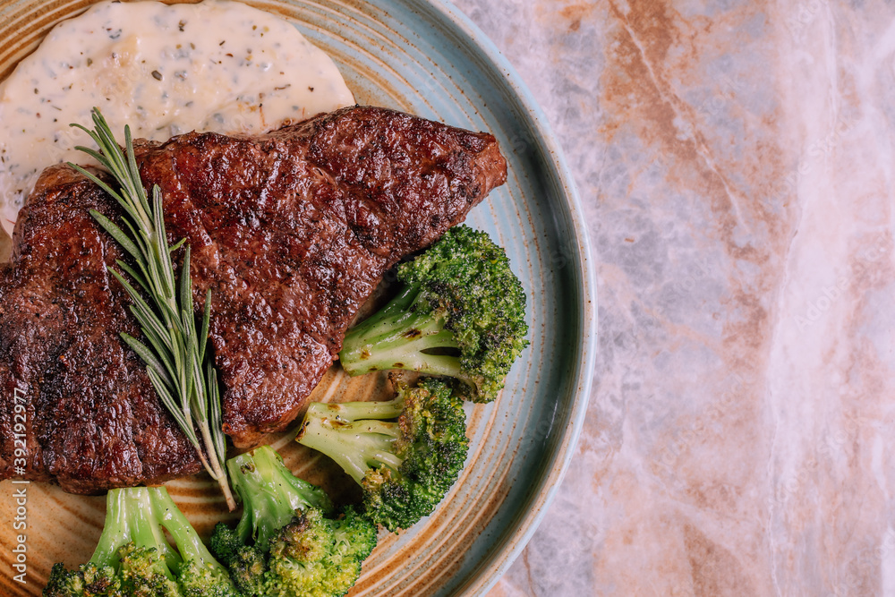 grilled beef steak with broccoli, rosemary and creamy sauce with garlic ...