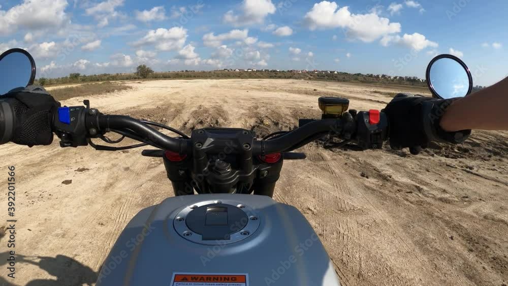 A motorcyclist rides along a trail with a beautiful landscape. View ...