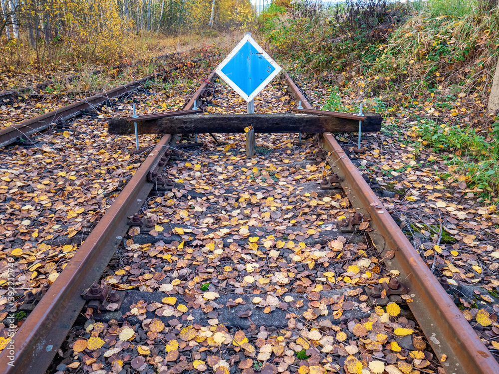 Closed abandoned railway in industry zone. End of track with a train ...