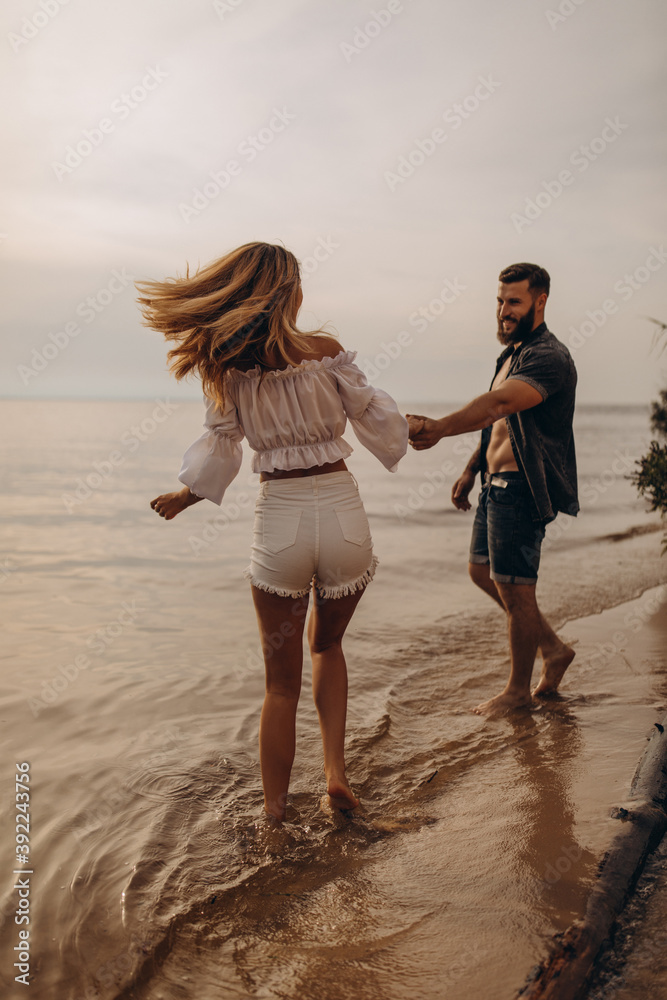 Romantic photo session of a young couple by the lake. Boy and girl ...