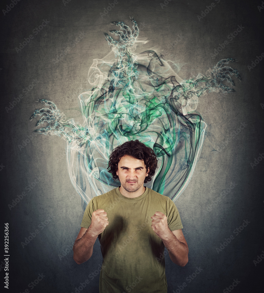 Furious man keeps fists clenched, looks strained as negative aura ...
