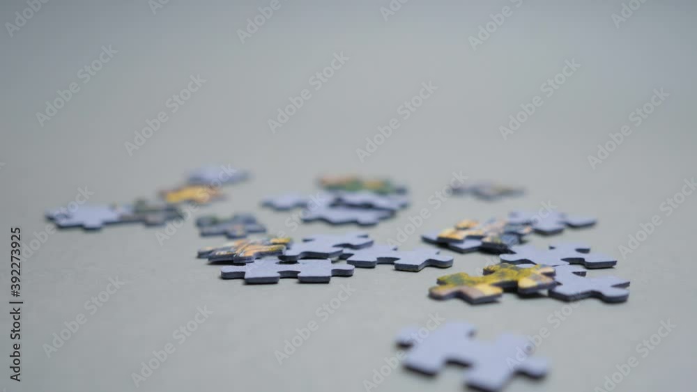 Close Up Jigsaw Puzzle Pieces Falling Down on Grey Background. Falling ...