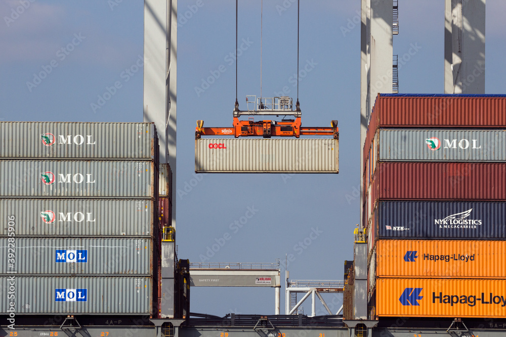 OOCL shipping container loaded in a container ship by gantry crane ...