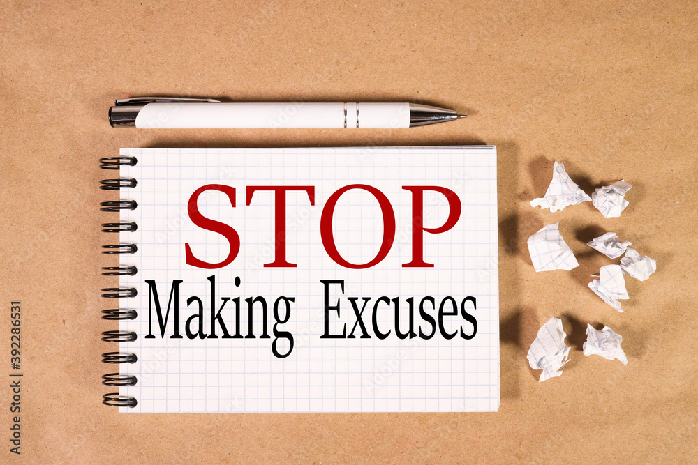 stop making excuses, text on white paper over kraft paper background ...