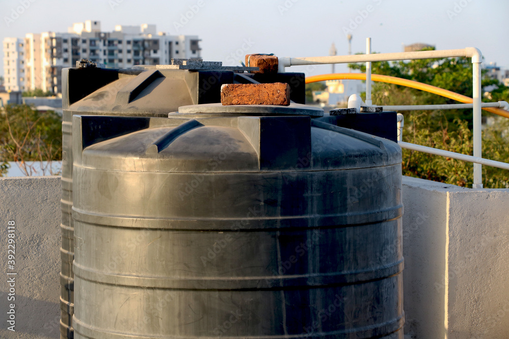 Big water tank with brick on container cover on top of roof top Stock ...