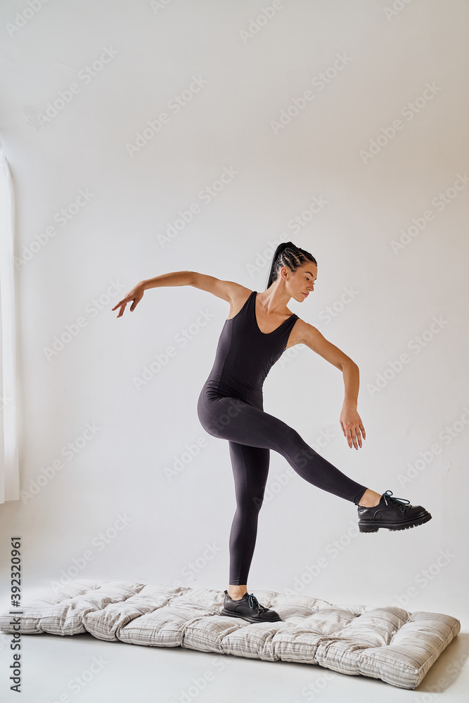 online trainer female dancer flexing her muscles before coming up with ...