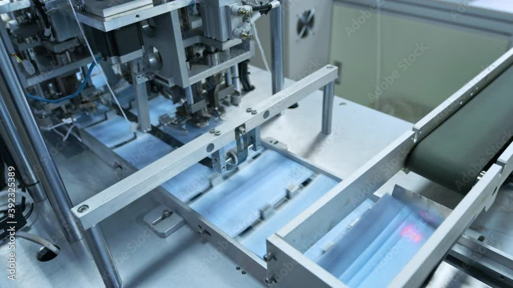 Production of medical three-layer blue or white masks. New masks move ...