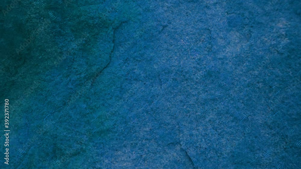 4K rain drop on heavy hard granite dark blue stone surface of cave for ...