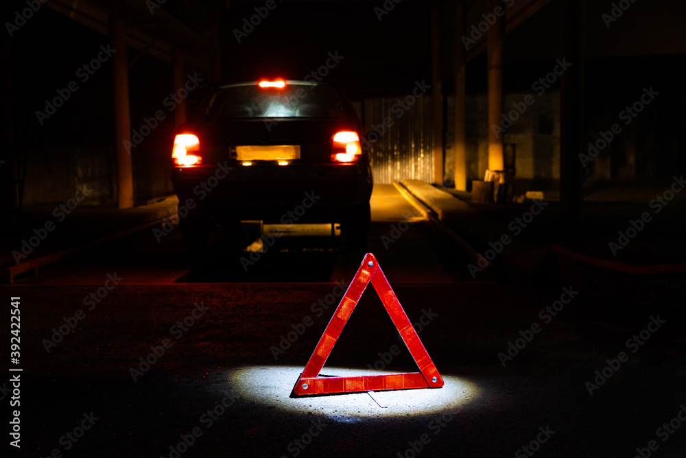 Stockfoto Red warning sign on the road at night in the light of a ...