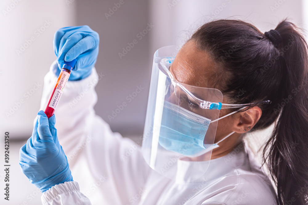 Healthcare employee wearing proper personal protective equipment looks ...