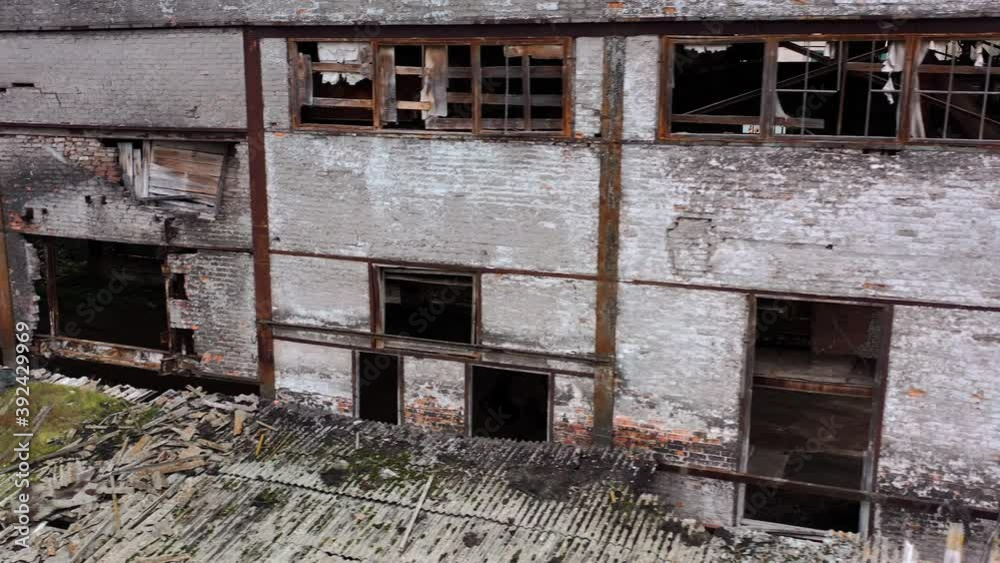 Damaged building with broken windows. Abandoned place after the war ...