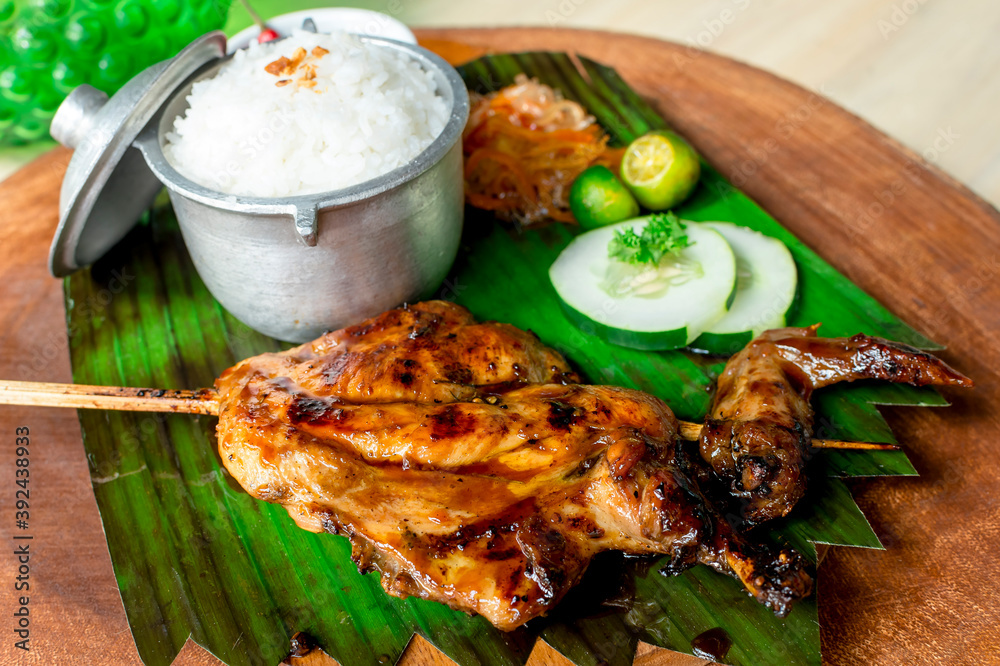 Juicy Chicken Inato with a serving of garlic rice and atchara. A ...