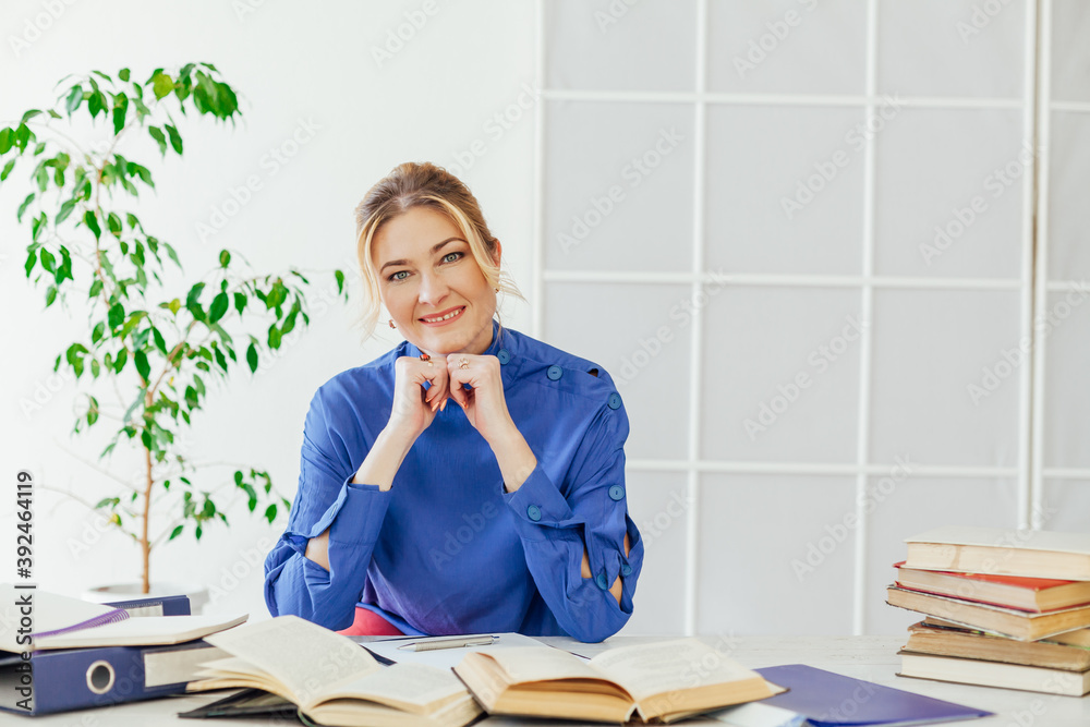 beautiful business woman in business suit at work in the office at the ...