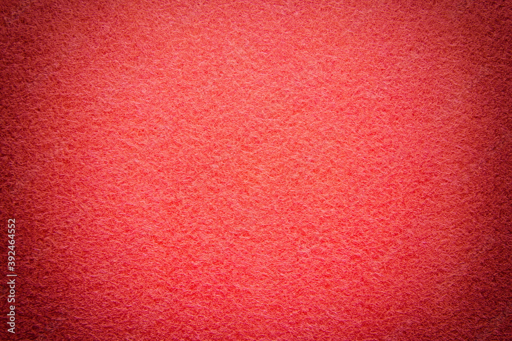Abstract background of intense red felt material with vignette ...