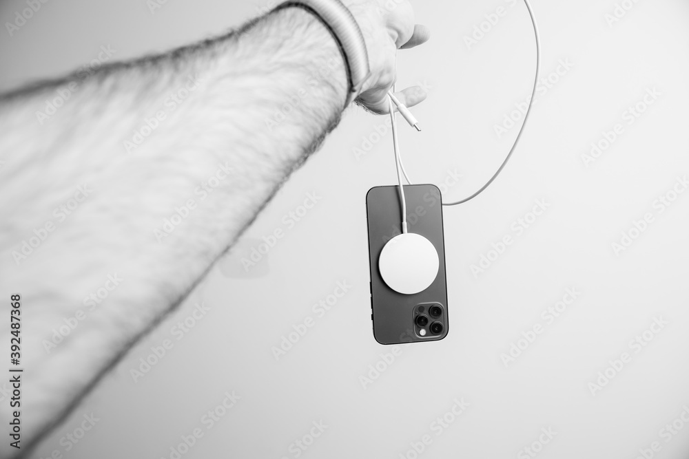 Paris, France - Nov 11, 2020: Man hand holding by lighting cable the ...