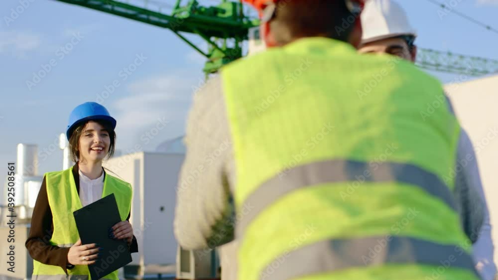 Posing on the construction site engineer lady and businessman at the ...