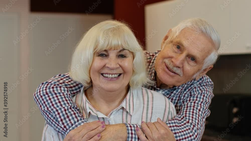 Senior family couple hugging, laughing, smiling looking at camera ...