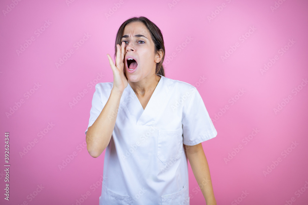 Young brunette doctor girl wearing nurse or surgeon uniform over ...