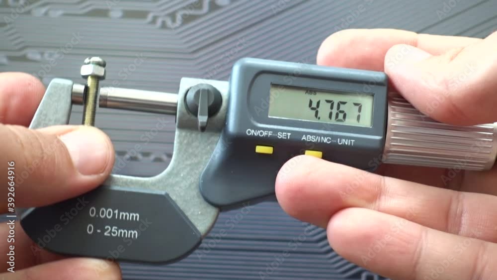 Engineer working with precise micrometer with digital display for ...
