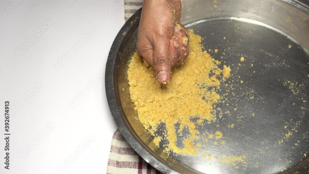 A female hand rolling "Laddu" in hand during diwali festival. Sweet ...