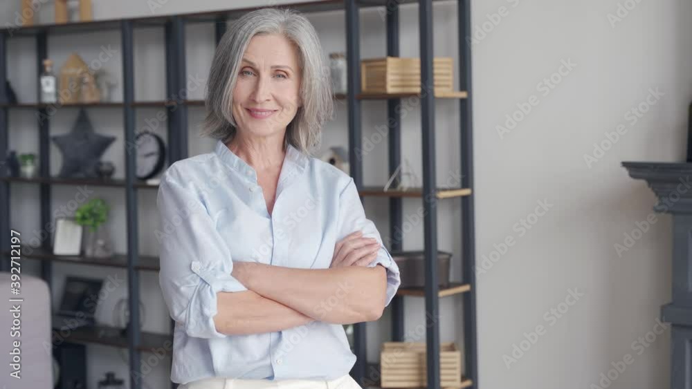 Video Stock Smiling confident stylish mature middle aged woman standing ...