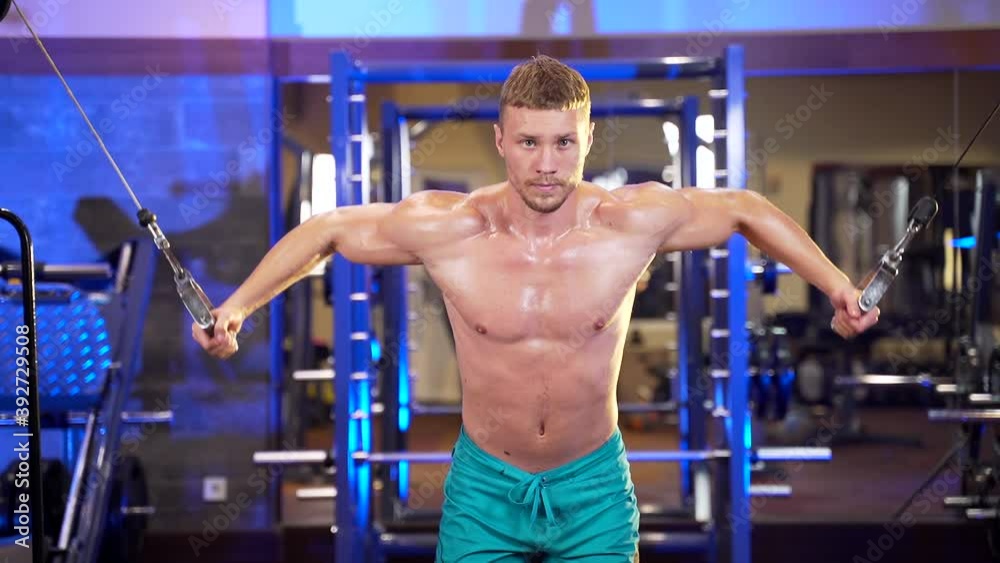 athletic fitness man doing pulling exercises working out in gym with ...