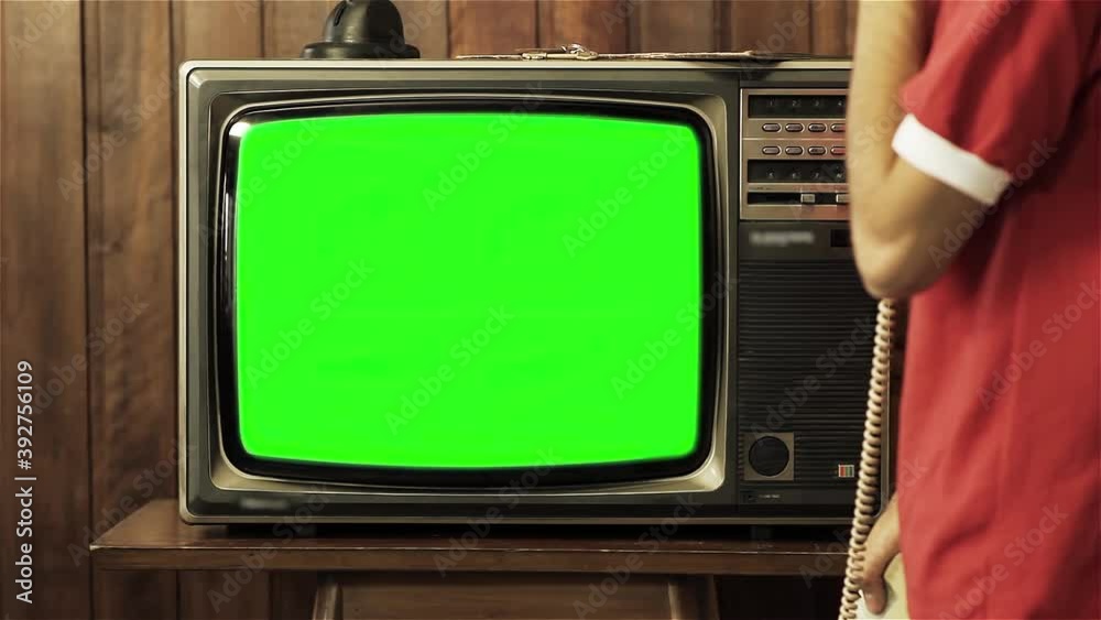 Young Man holding Old Telephone and Watching Retro TV Green Screen. You ...