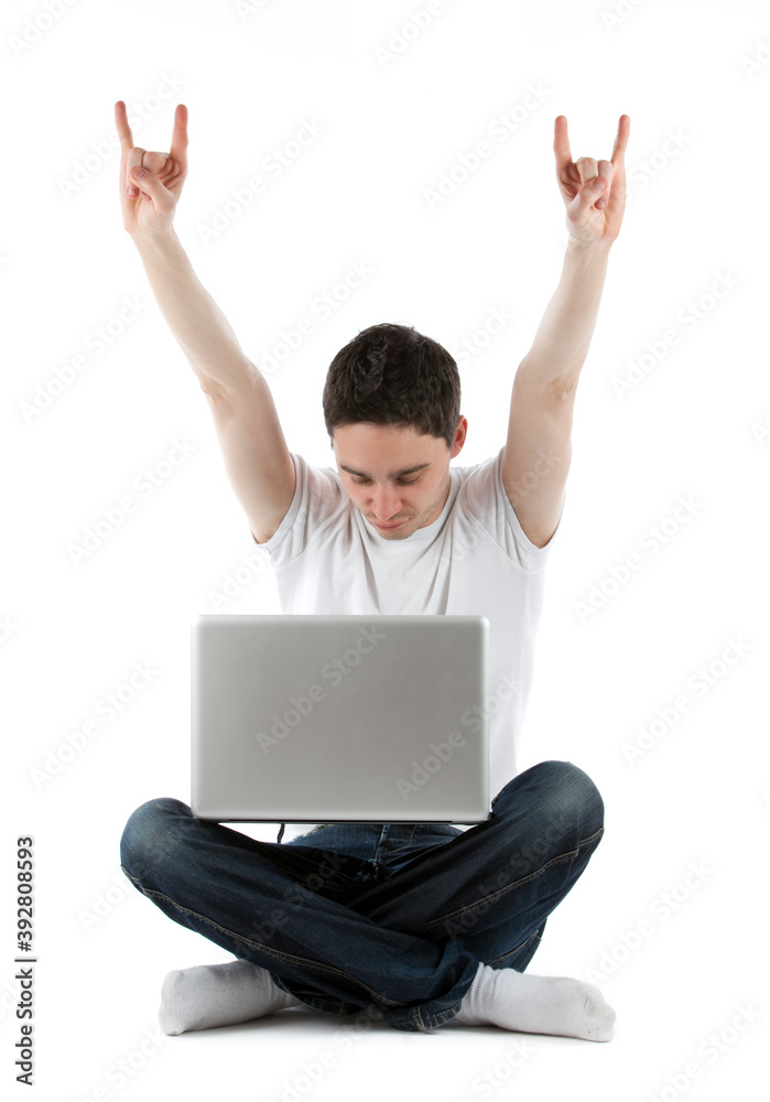 Young caucasian dark haired man sitting with crossed legs with his ...