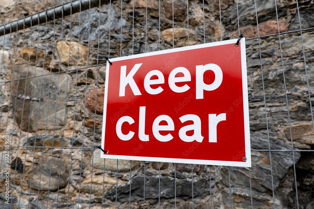 Keep clear warning sign on a metal fence during reconstruction of a ...