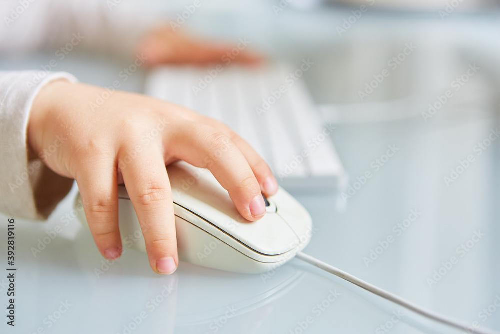 Small child operates computer mouse by hand Stock Photo | Adobe Stock