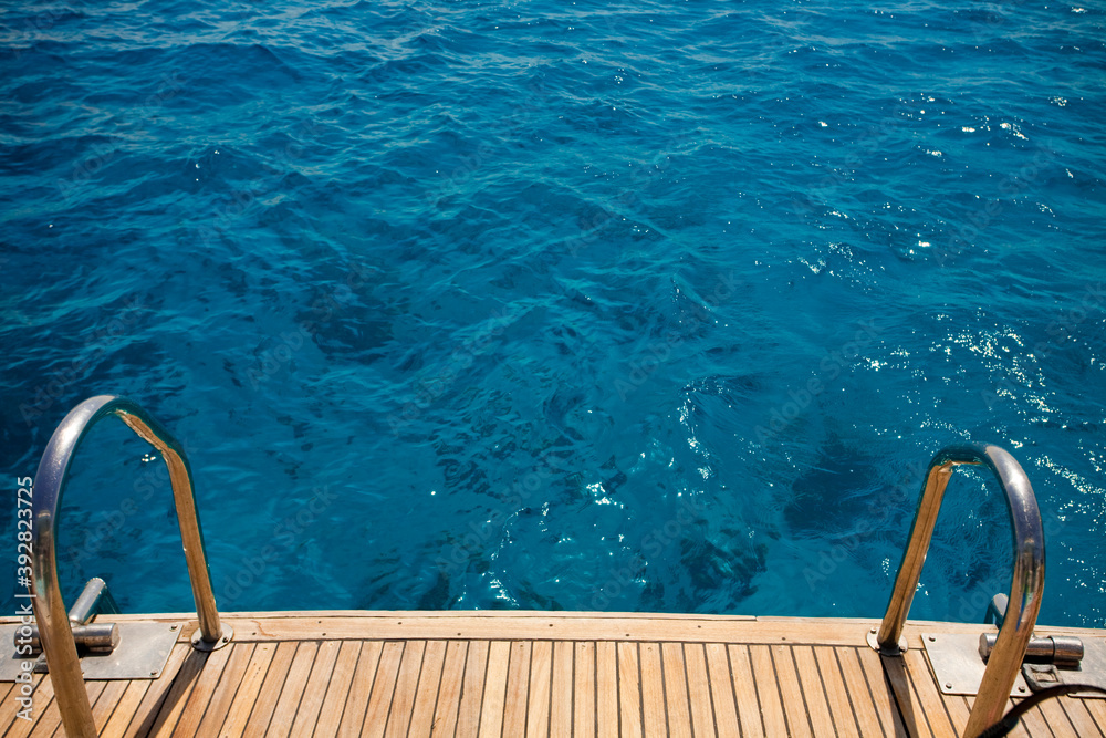 Diving deck on a yacht, looking down the ocean. Stock Photo | Adobe Stock