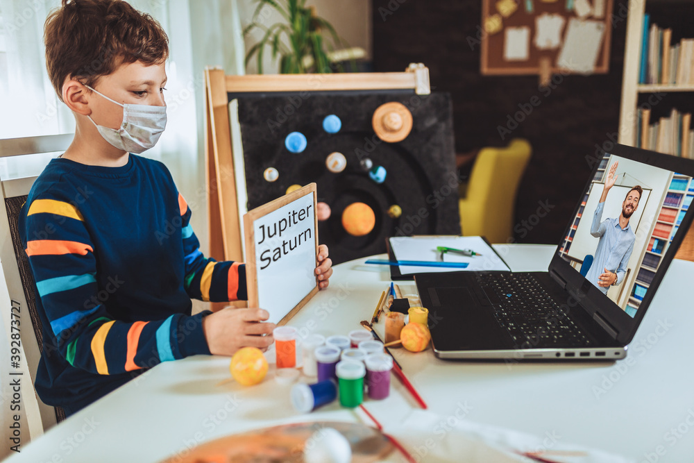 Kid with protective mask presenting their science home project - the ...