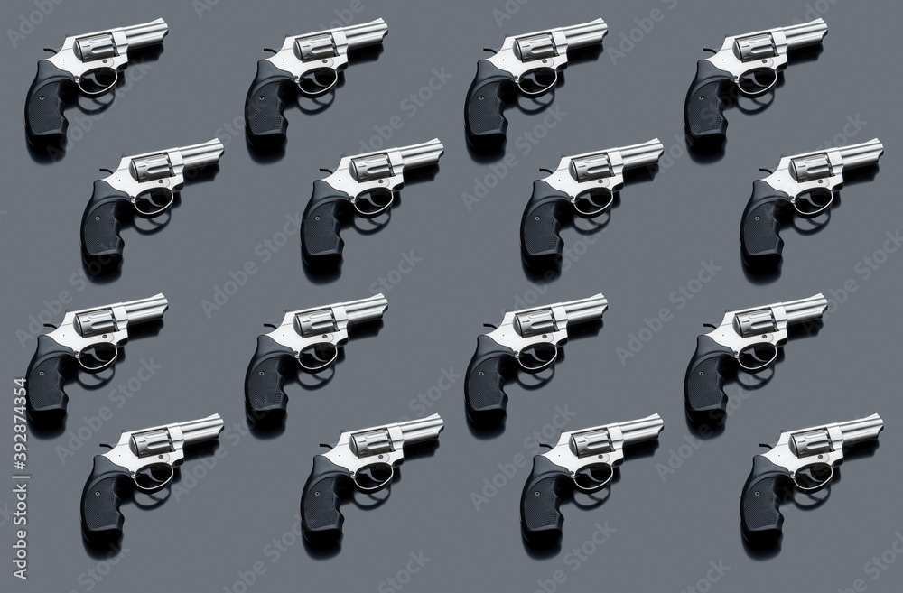 Silver revolver pistol on a light back. The classic weapon of the wild ...