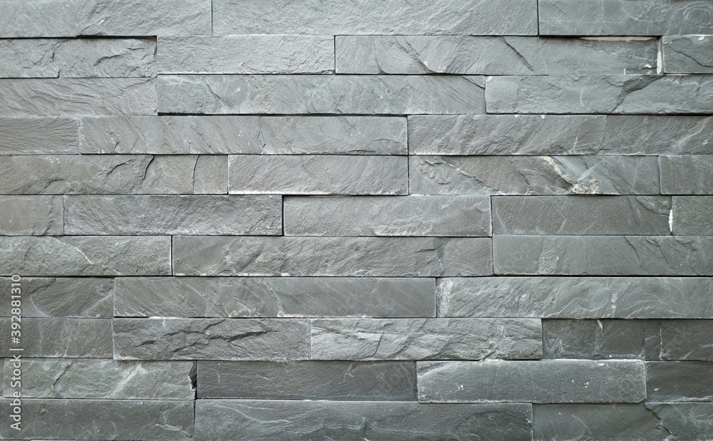 Stone wall cladding made of horizontal gray bricks of natural rock ...