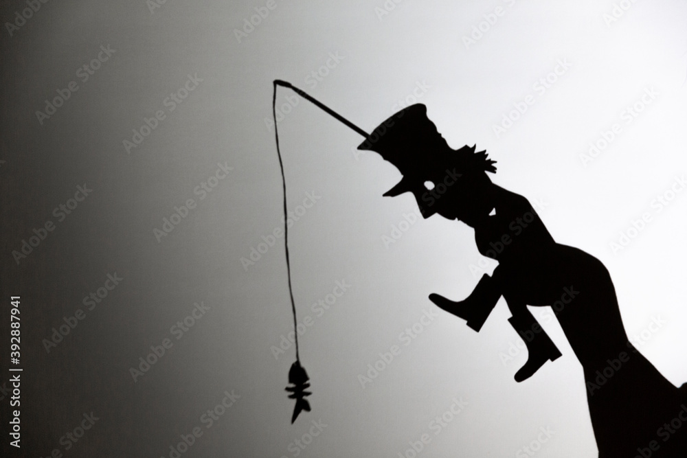 play shadow projected against a white background. a homeless man with a ...